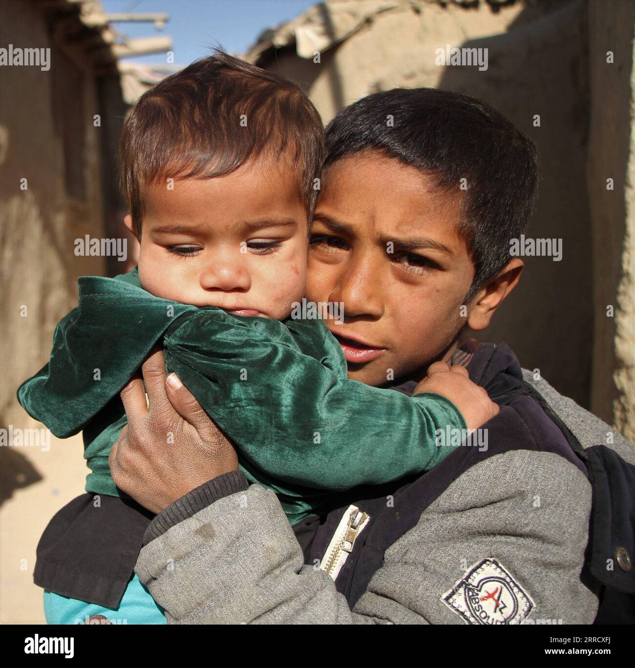 211121 -- KABUL, Nov. 21, 2021 -- A displaced child holds his brother ...