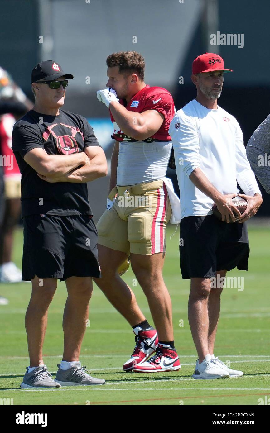 San Francisco 49ers defensive end Nick Bosa, middle, walks behind ...