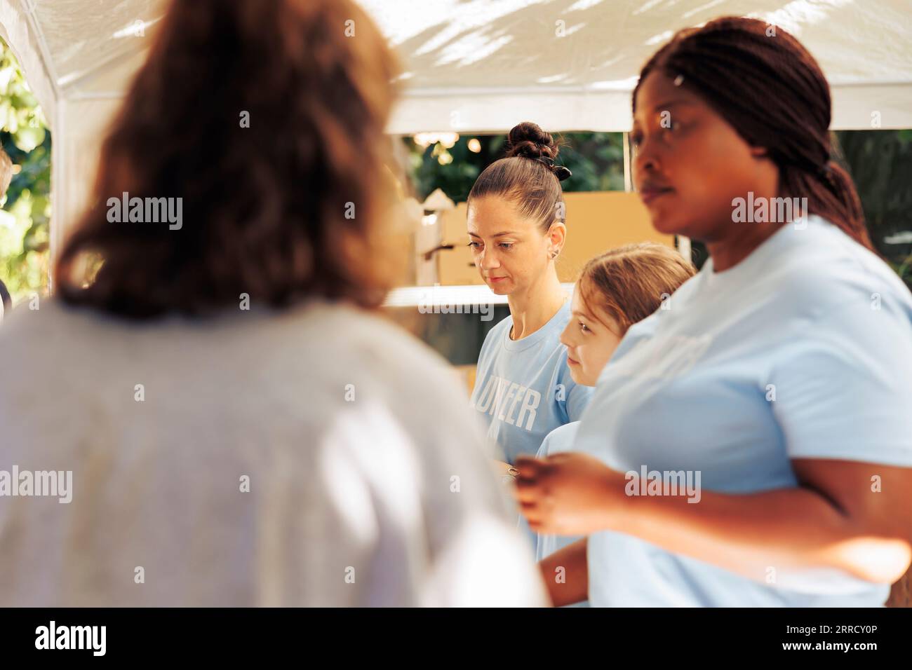 Image showing female volunteer crew at charitable center, distributing ...