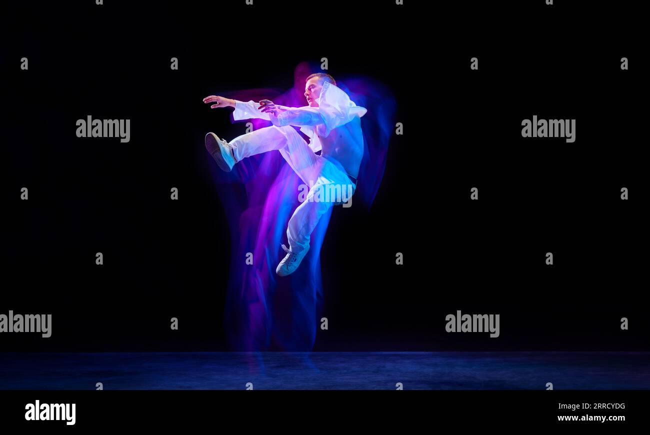 against black studio background in neon with mixed lights effect Stock ...