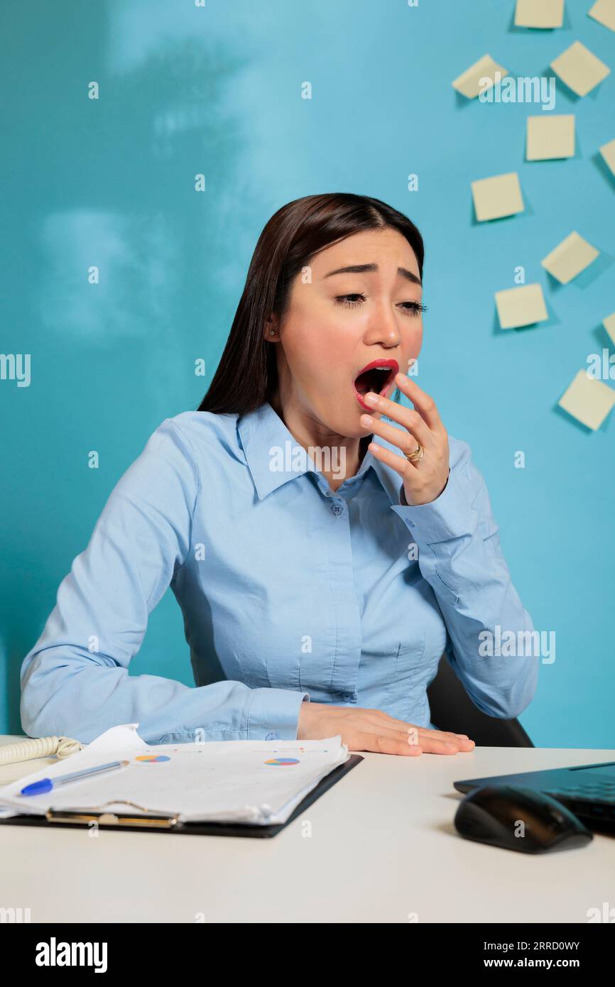 Corporate female employee working overtime in modern office, trying to ...