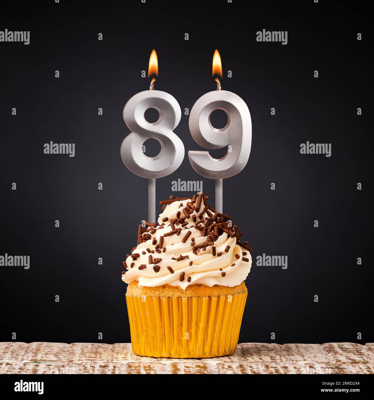 Birthday candle number 89 - Anniversary cupcake on black background ...