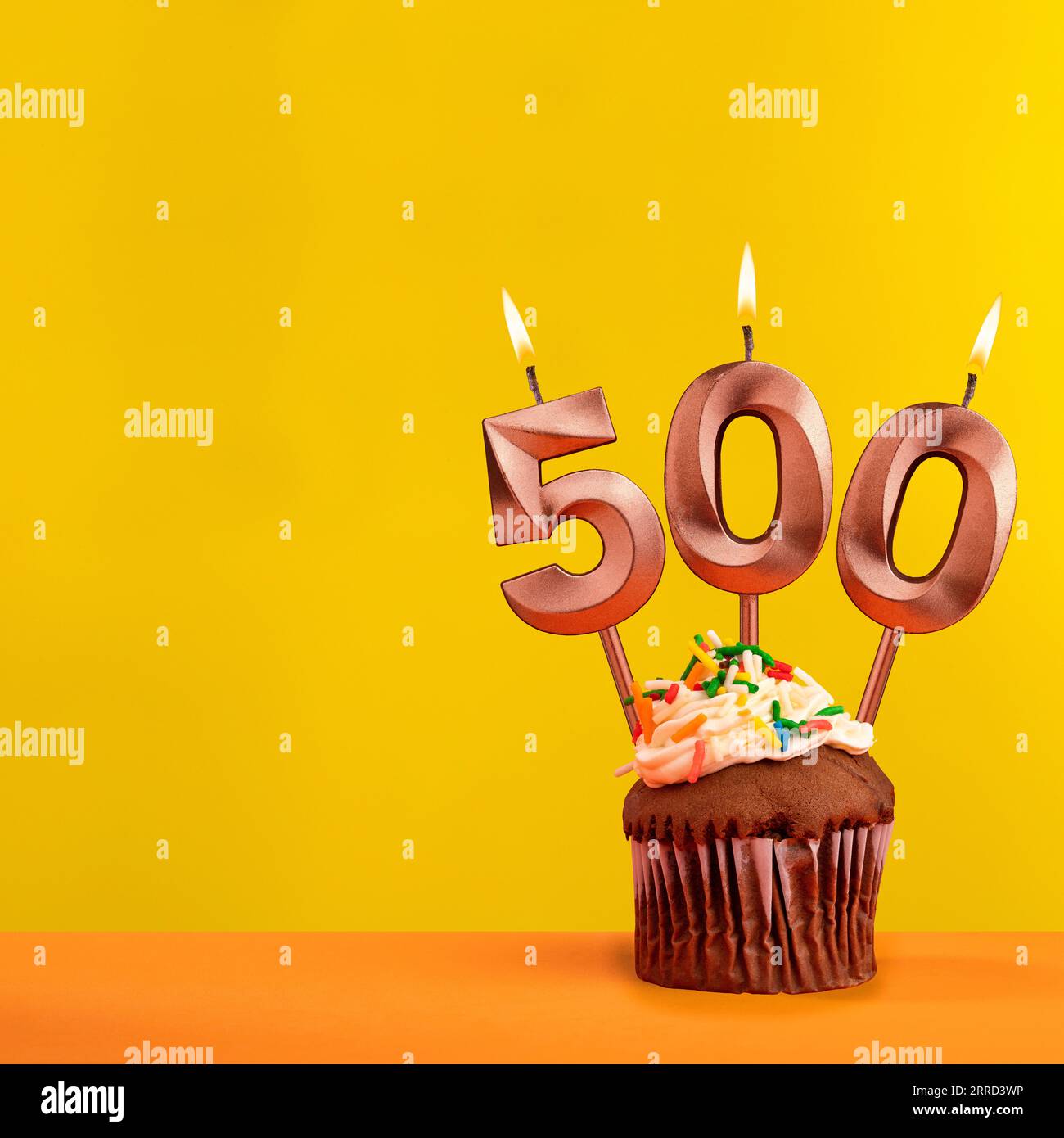 Number 500 anniversary candle - Celebration on yellow background Stock ...
