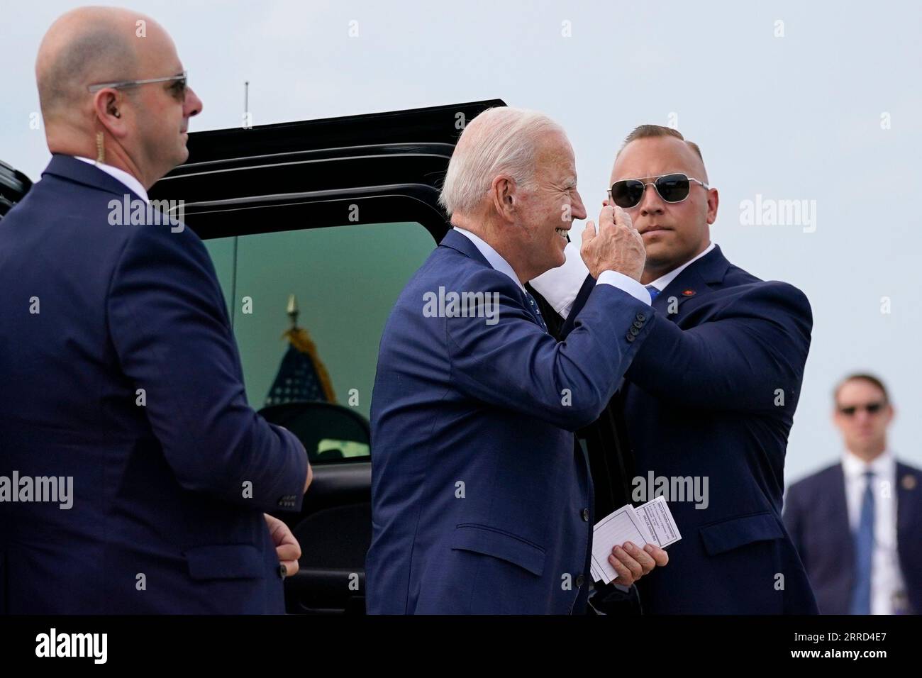 President Joe Biden returns a salute as he arrives to board Air Force ...