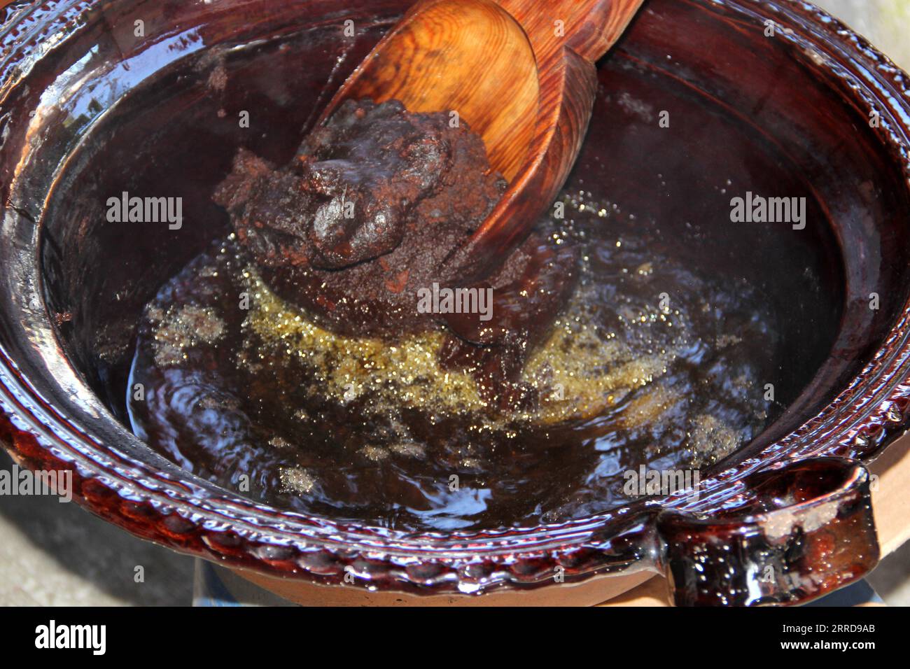 Preparation of red mole, a typical Mexican dish in a clay pot with a ...