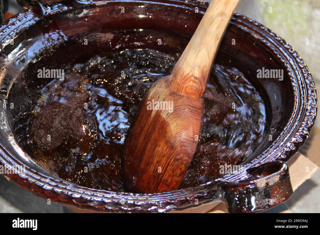 Preparation of red mole, a typical Mexican dish in a clay pot with a ...