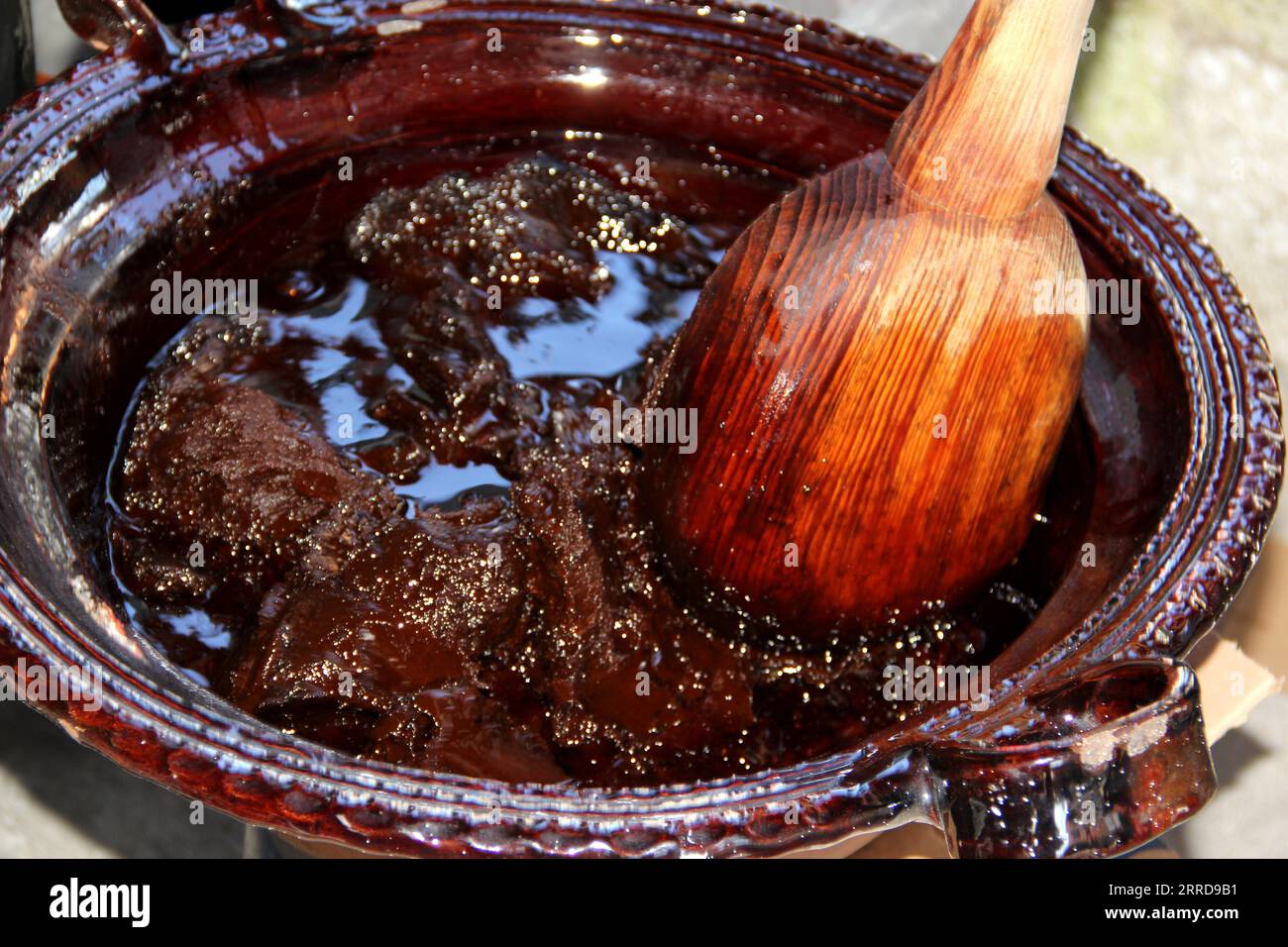Preparation of red mole, a typical Mexican dish in a clay pot with a ...