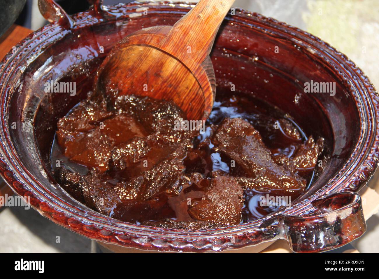 Preparation of red mole, a typical Mexican dish in a clay pot with a ...