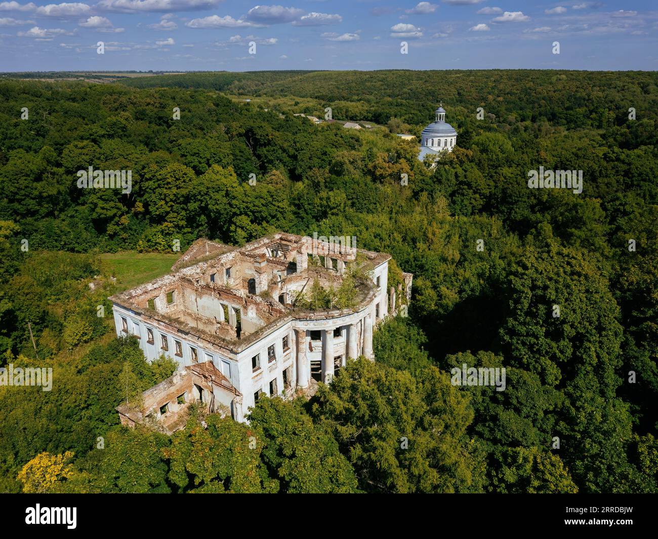 Aerial view of ruined overgrown old abandoned mansion. Former estate of ...