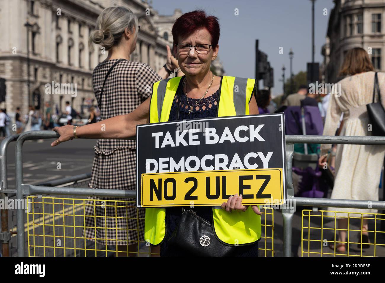 An anti-ULEZ protester holds a placard outside Parliament in London as ...