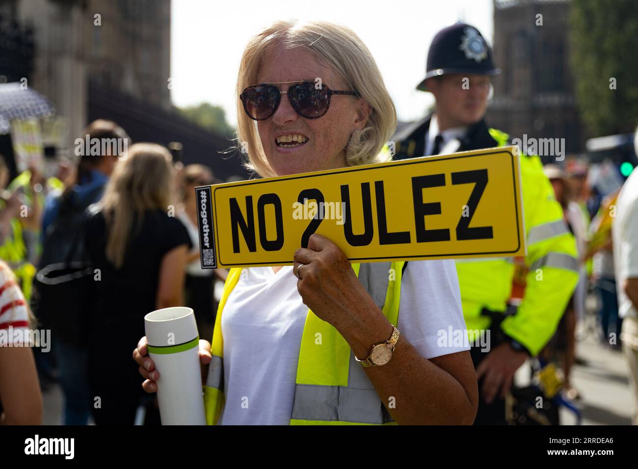 An anti-ULEZ protester holds a placard outside Parliament in London as ...