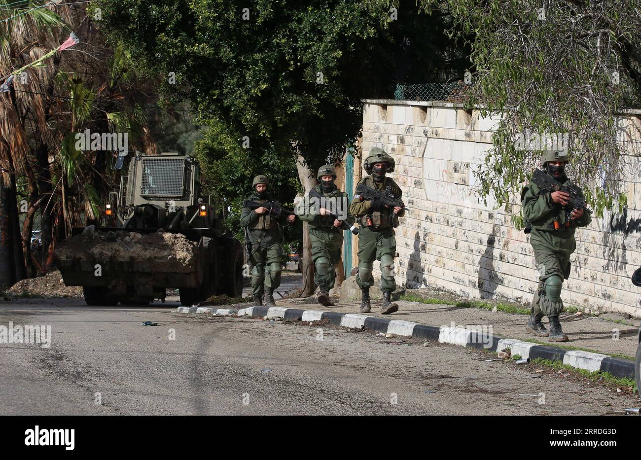 211223 -- NABLUS, Dec. 23, 2021 -- Israeli soldiers and a bulldozer are ...