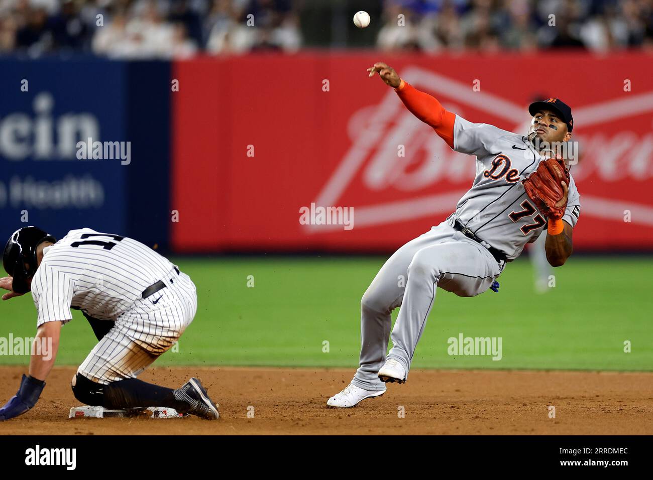 Detroit Tigers second baseman Andy Ibanez falls as he throws to first base after forcing out New ...