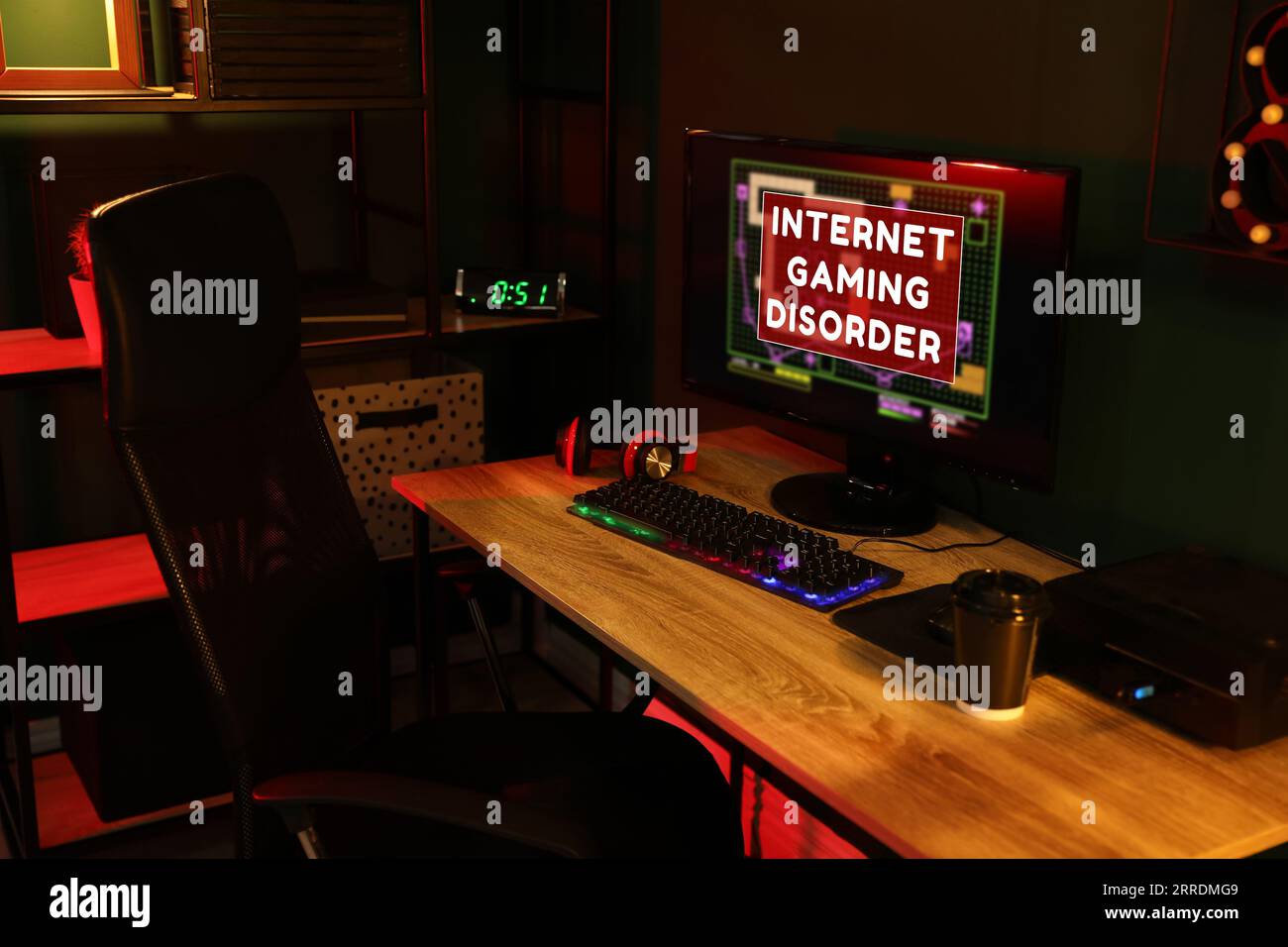 Internet gaming disorder. Modern computer and RGB keyboard on wooden ...