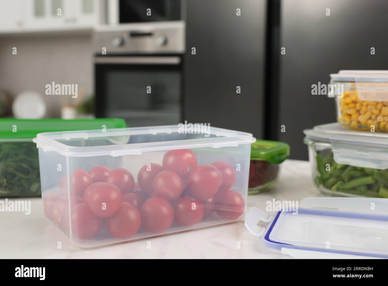 Plastic and glass containers with different fresh products on white ...