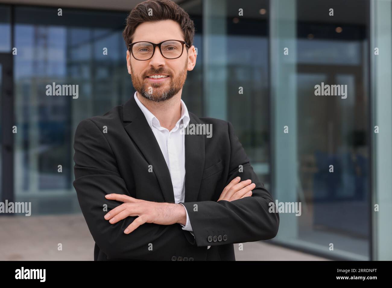 Happy real estate agent in suit outdoors Stock Photo - Alamy