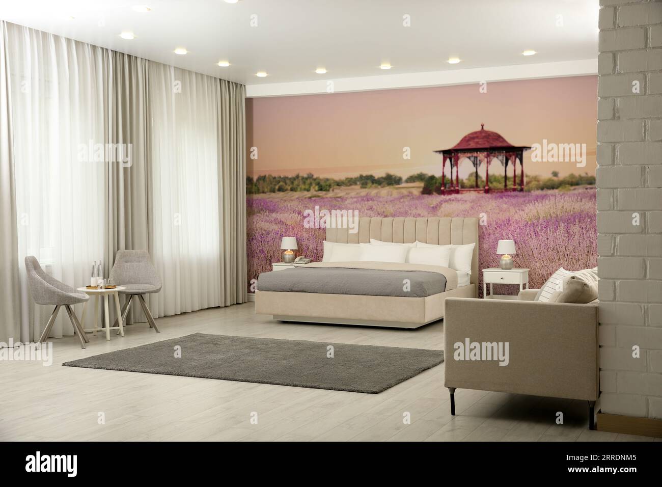 Light cozy bedroom. Interior with large bed and landscape wallpapers ...