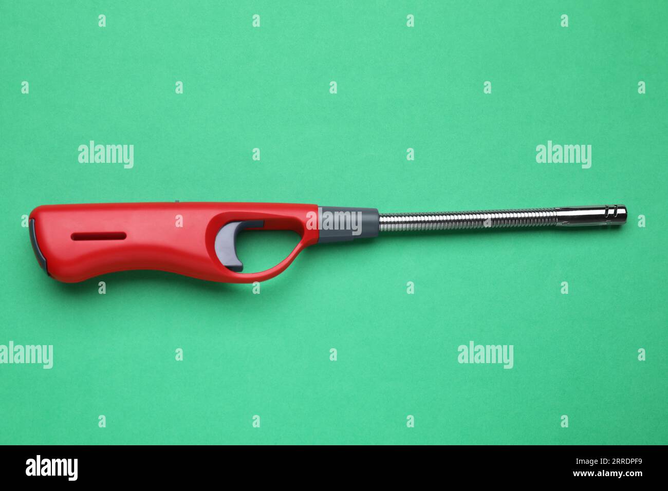 One gas lighter on green background, top view Stock Photo - Alamy