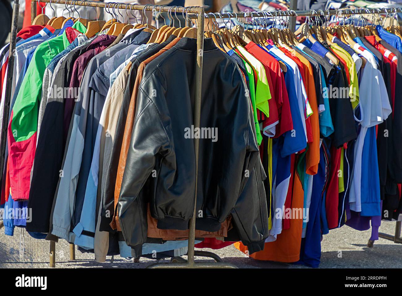 Colorful second hand clothes sold outdoors on flea market Stock Photo ...