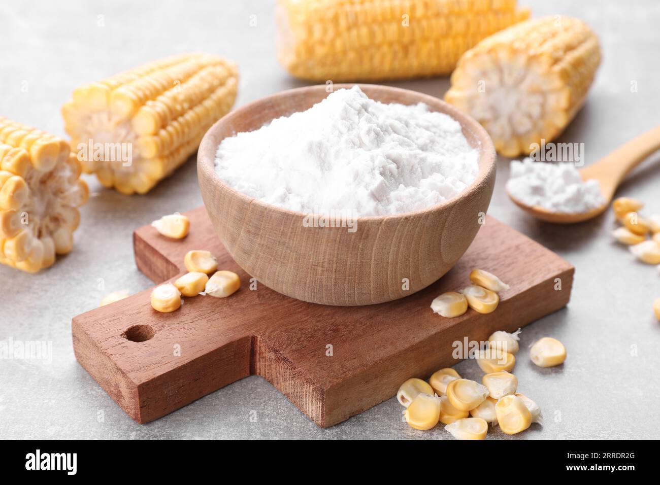Bowl with corn starch and kernels on light grey table, closeup Stock ...
