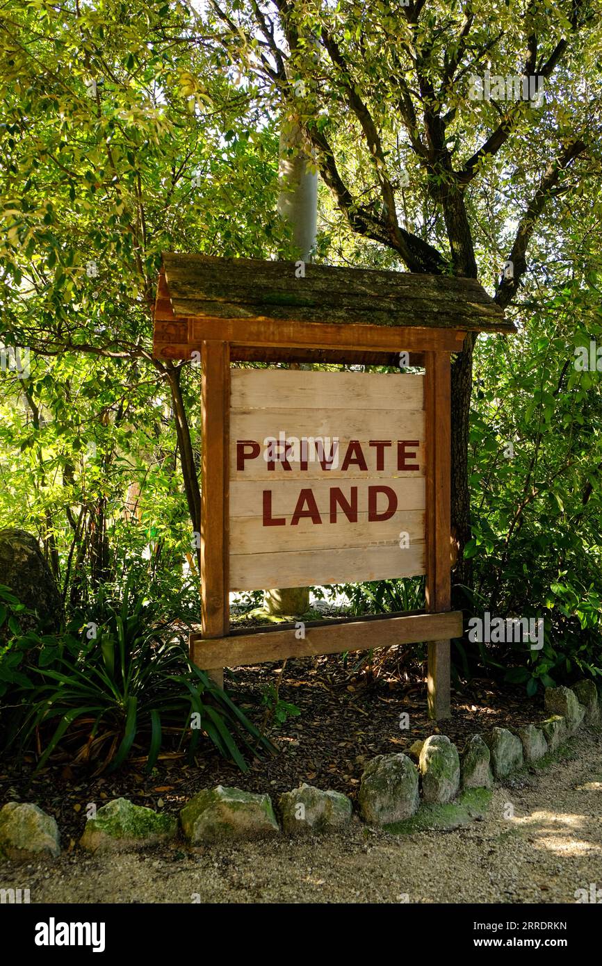 Wooden sign with text Private Land outdoors Stock Photo - Alamy