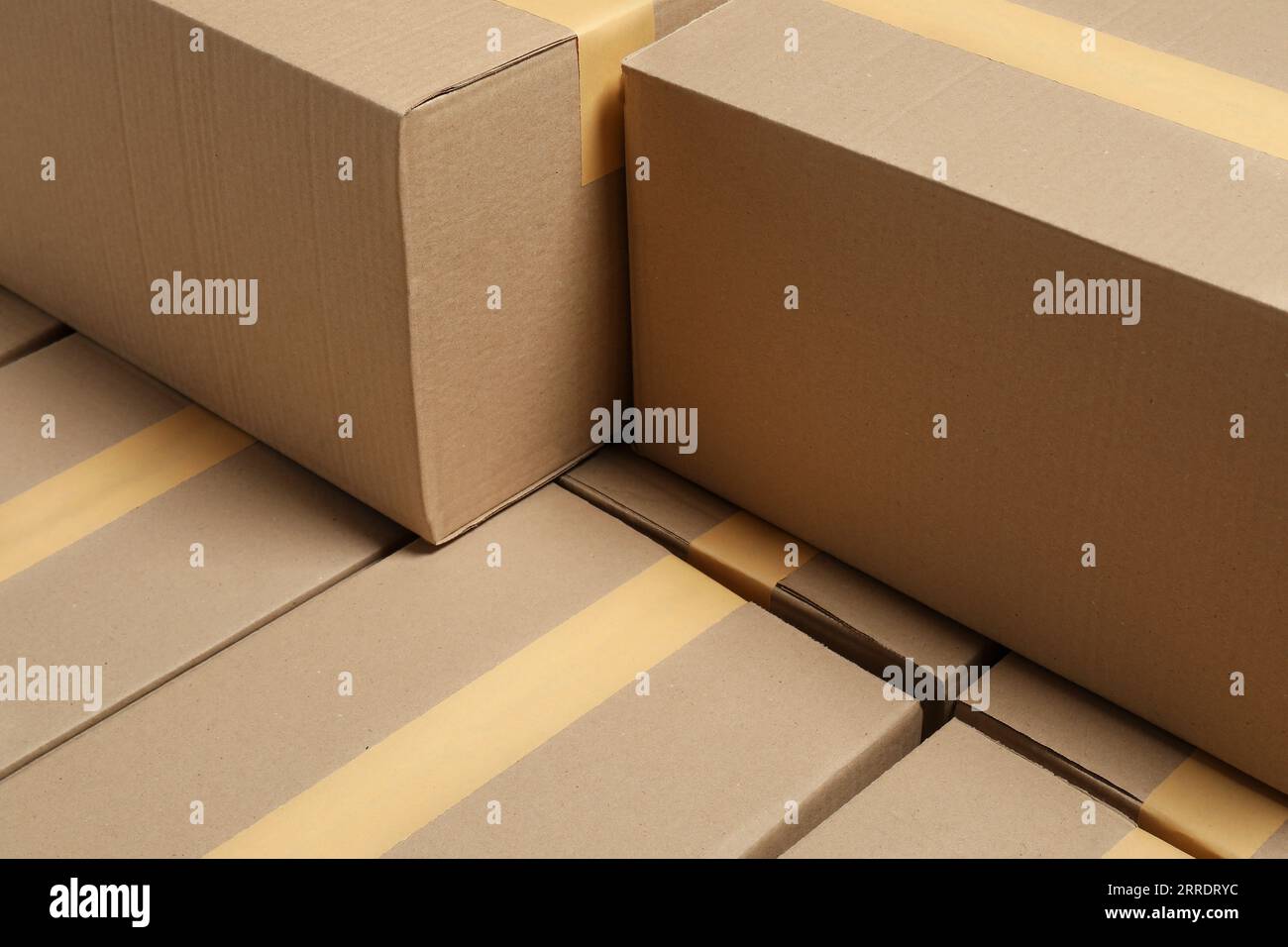 Many closed cardboard boxes as background. Packaging goods Stock Photo ...