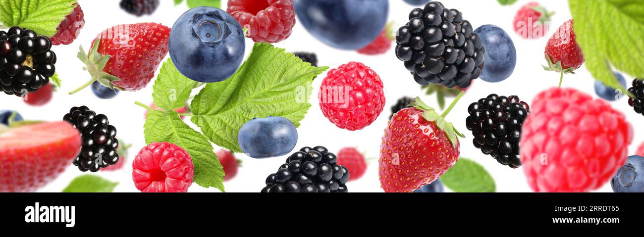 Many different berries flying on white background Stock Photo - Alamy