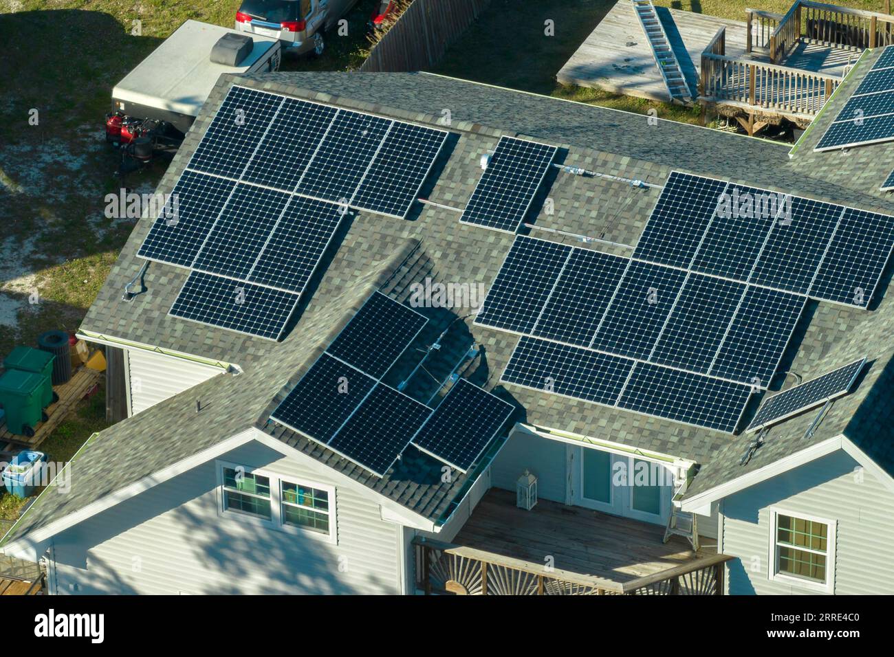 Aerial view of regular american home roof with blue solar photovoltaic ...