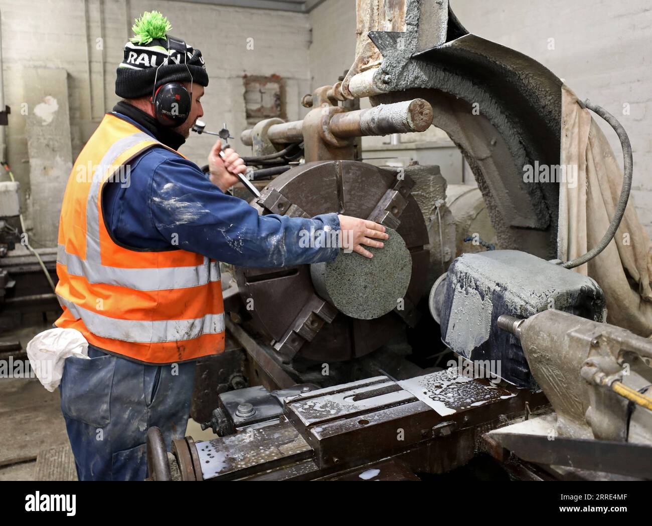 220127 -- MAUCHLINE, Jan. 27, 2022 -- A man works in Kays Curling ...