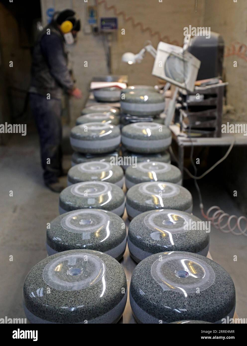 220127 -- MAUCHLINE, Jan. 27, 2022 -- A man works in Kays Curling ...
