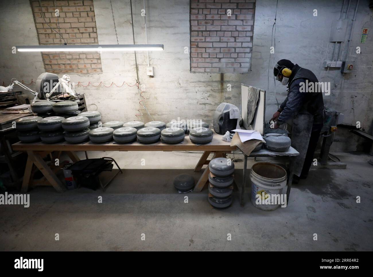 220127 -- MAUCHLINE, Jan. 27, 2022 -- A man works in Kays Curling ...