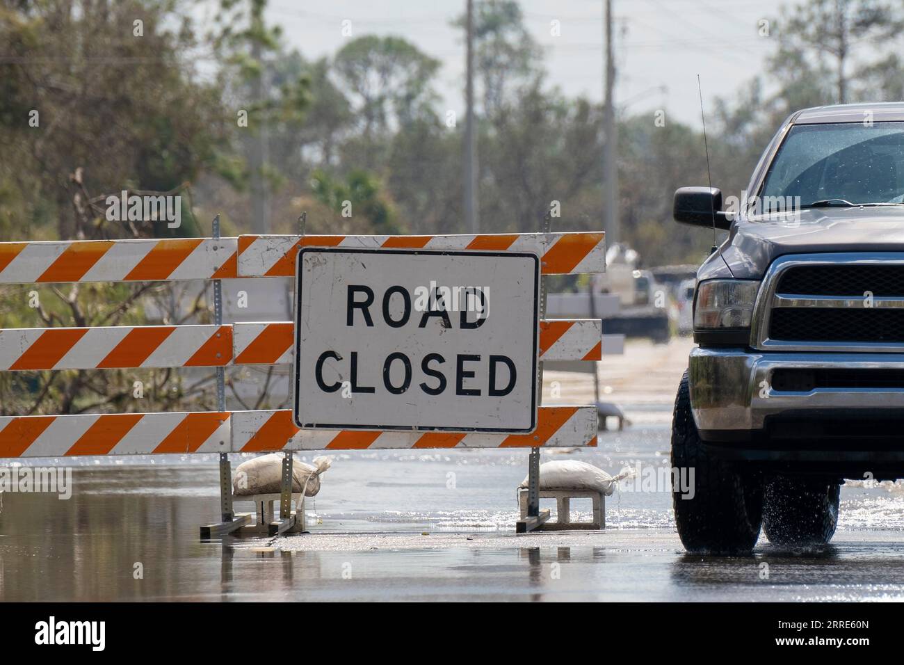 Flooded street in Florida after hurricane rainfall with road closed ...