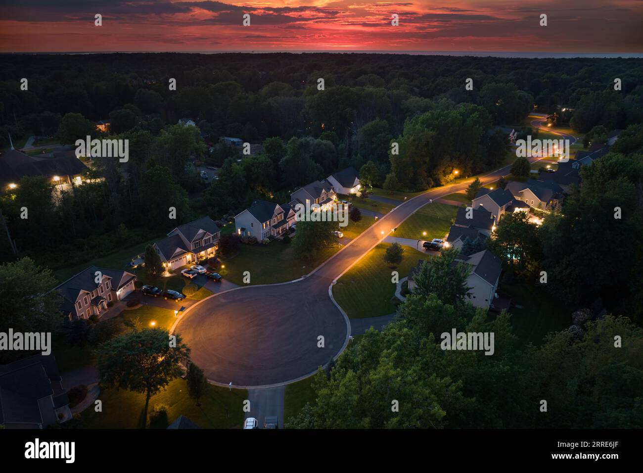 Low-density two story private homes at sunset. Rural street cul-de-sac ...