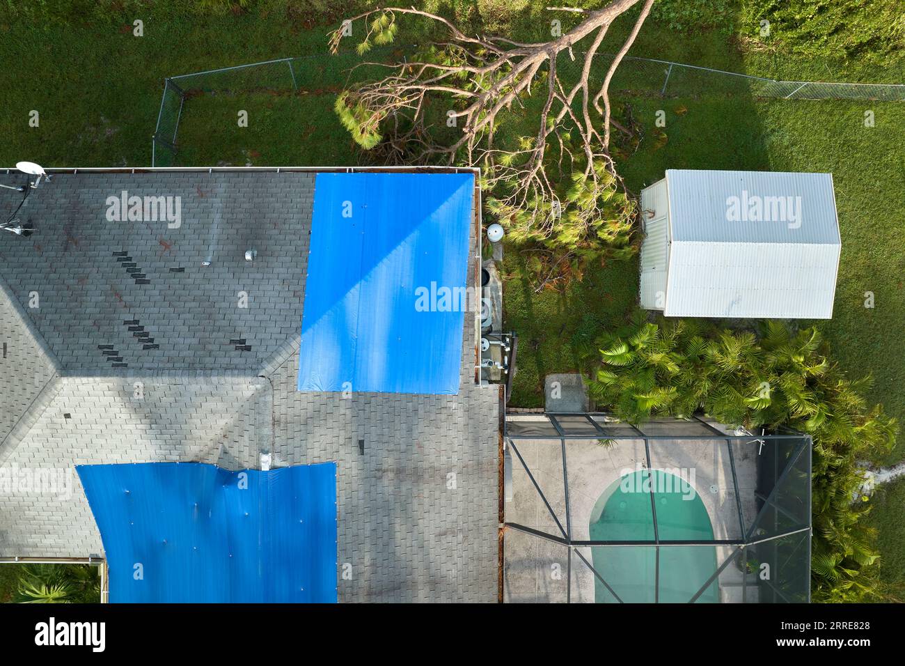 Top view of leaking house roof covered with protective tarp sheets ...