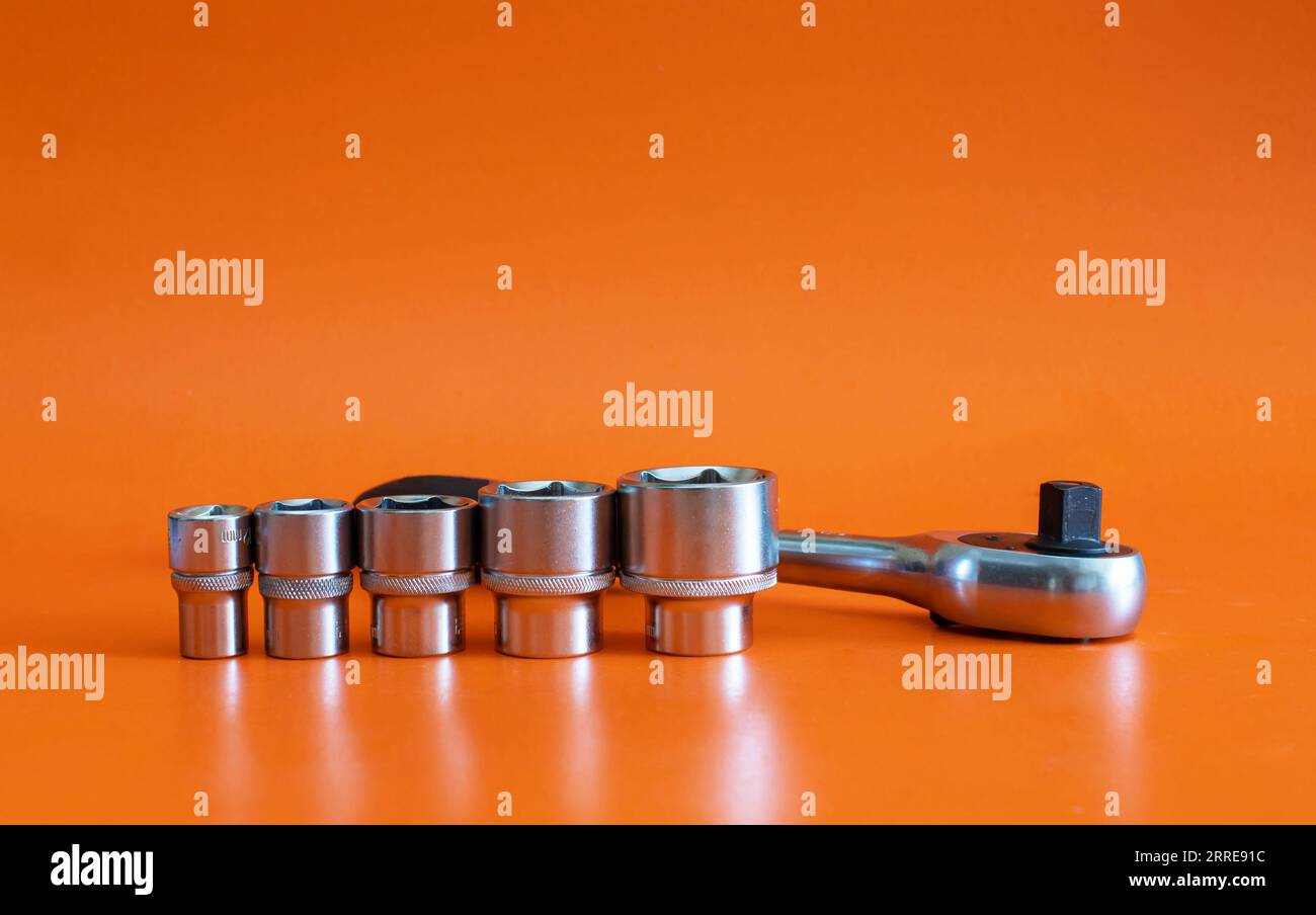 Set of wrenches, locks and ratchet wrenches on orange background. set ...