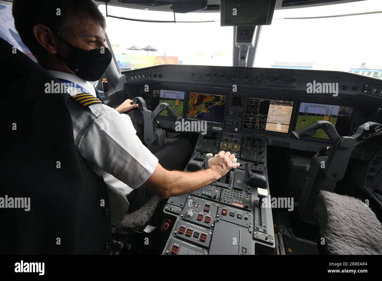 220215 -- SINGAPORE, Feb. 15, 2022 -- A pilot introduces the cockpit of ...