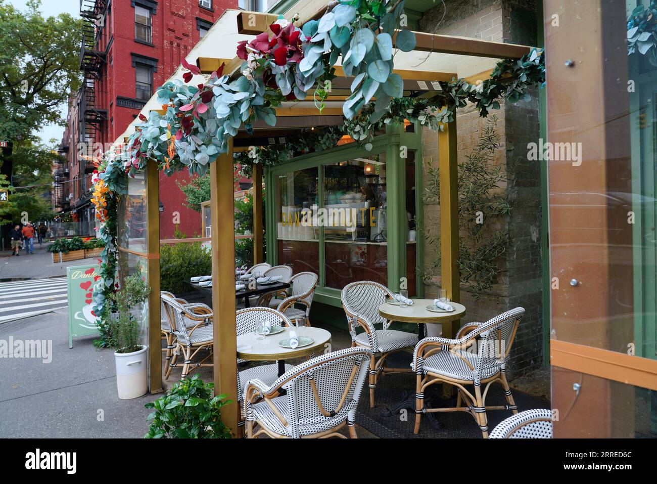 New York City street scene in West Village with outdoor cafe on ...