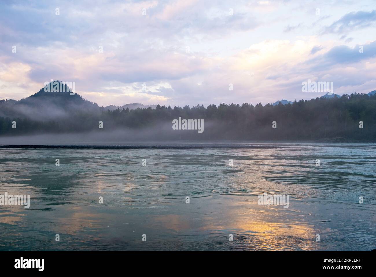 A wide, full-flowing mountain river with a fast current Stock Photo - Alamy