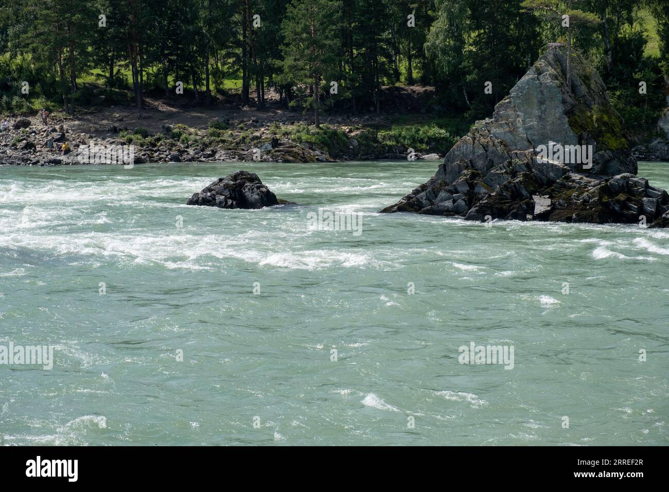 A wide, full-flowing mountain river with a fast current Stock Photo - Alamy