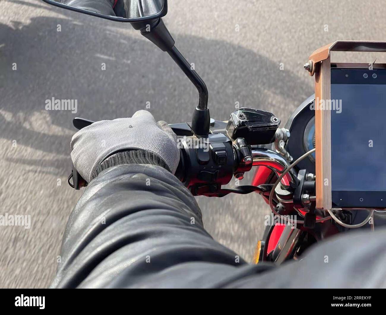 220307 -- KIGALI, March 7, 2022 -- A motorbike taxi driver rides an e ...