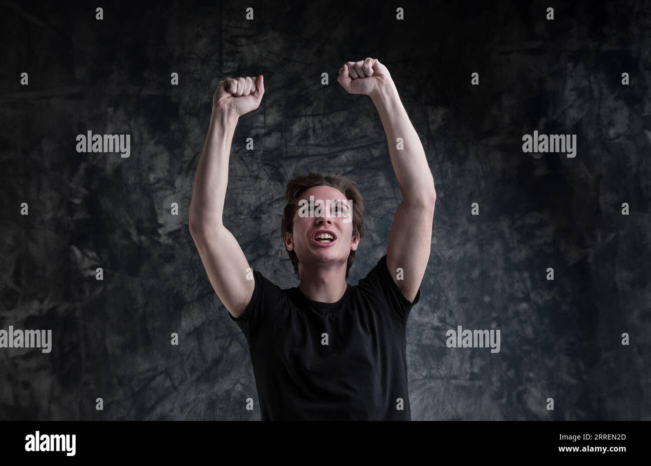 Victory is clear on a young man's smiling face. Light-brown hair, black ...