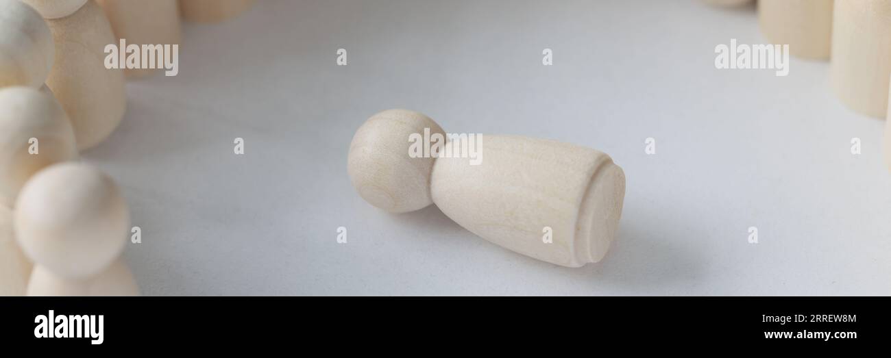 One wooden figure laying in circle of many people figures Stock Photo ...