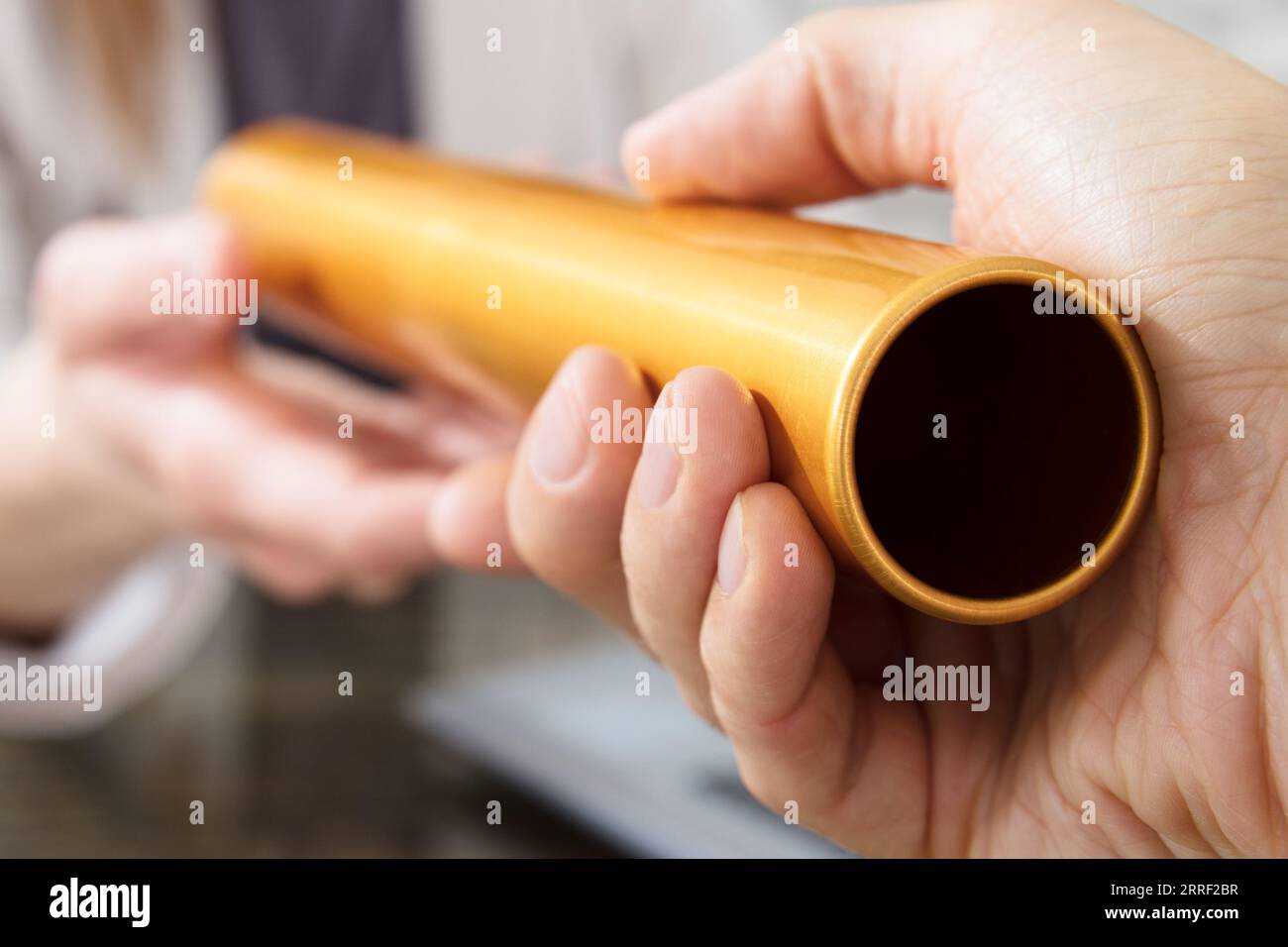 Hand passing golden baton hi-res stock photography and images - Alamy