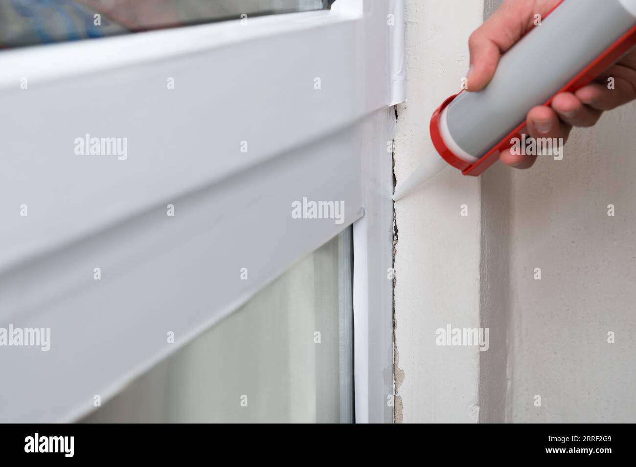 Close-up Of Person Hands Applying Silicone Sealant With Caulking Gun ...