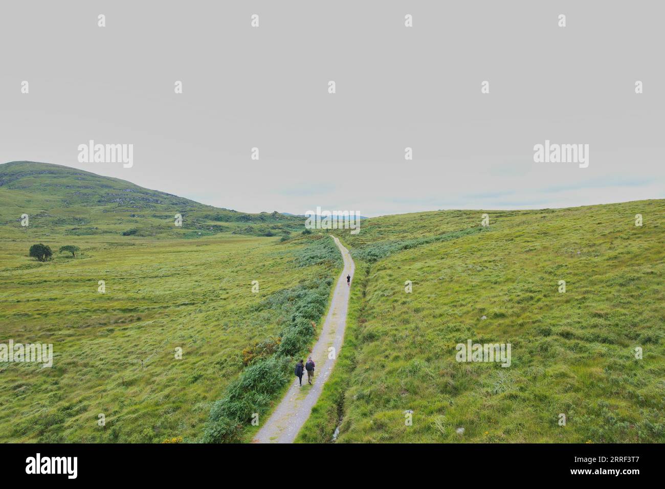 Walking up grassy slope hi-res stock photography and images - Alamy