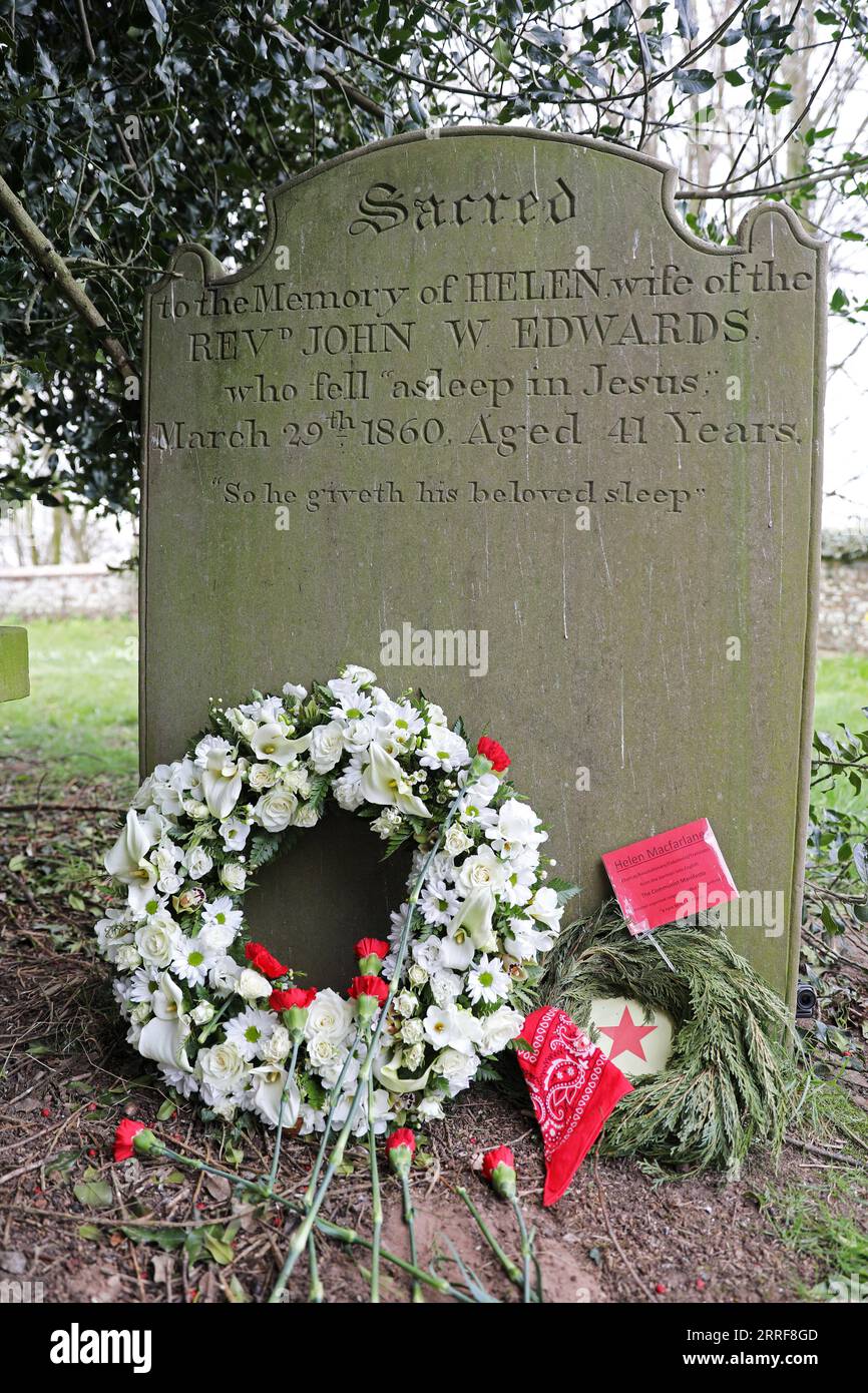 220404 -- CHESHIRE, April 4, 2022 -- Flowers and wreaths are seen on ...