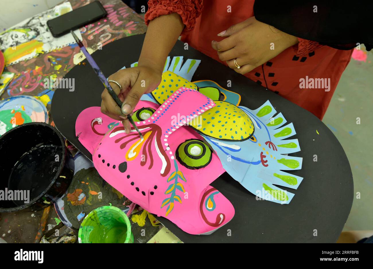 220411 -- DHAKA, April 11, 2022 -- A student paints a traditional paper ...