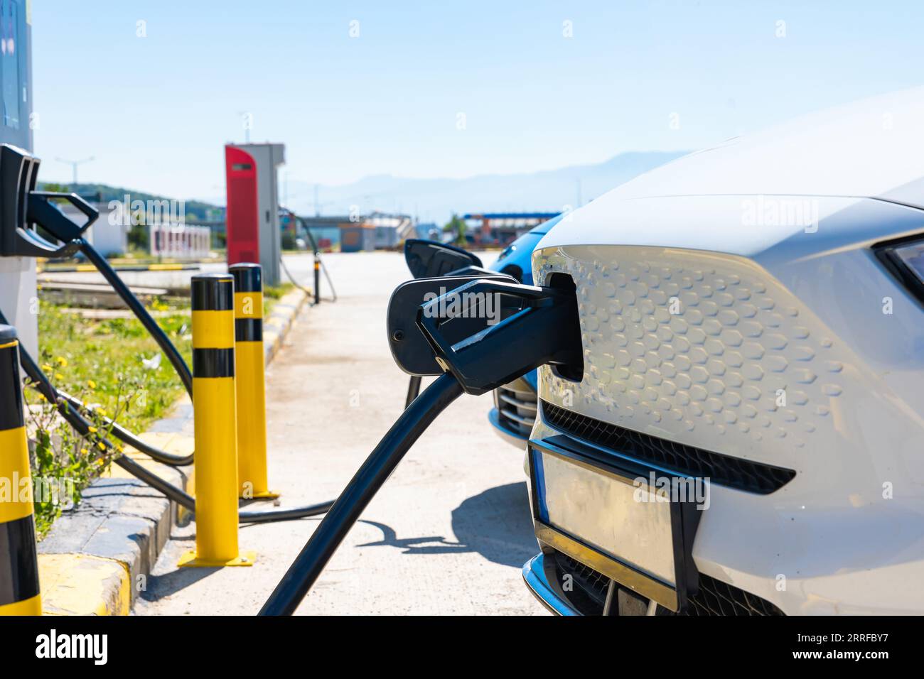 EV car charging outside. Close up view of a charging electric car. EV ...