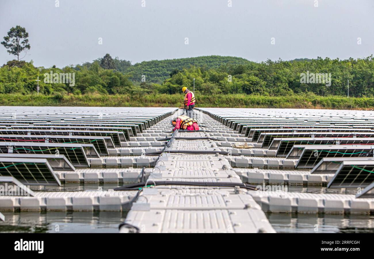 220412 -- RAYONG, April 12, 2022 -- Staff members check the cable of ...