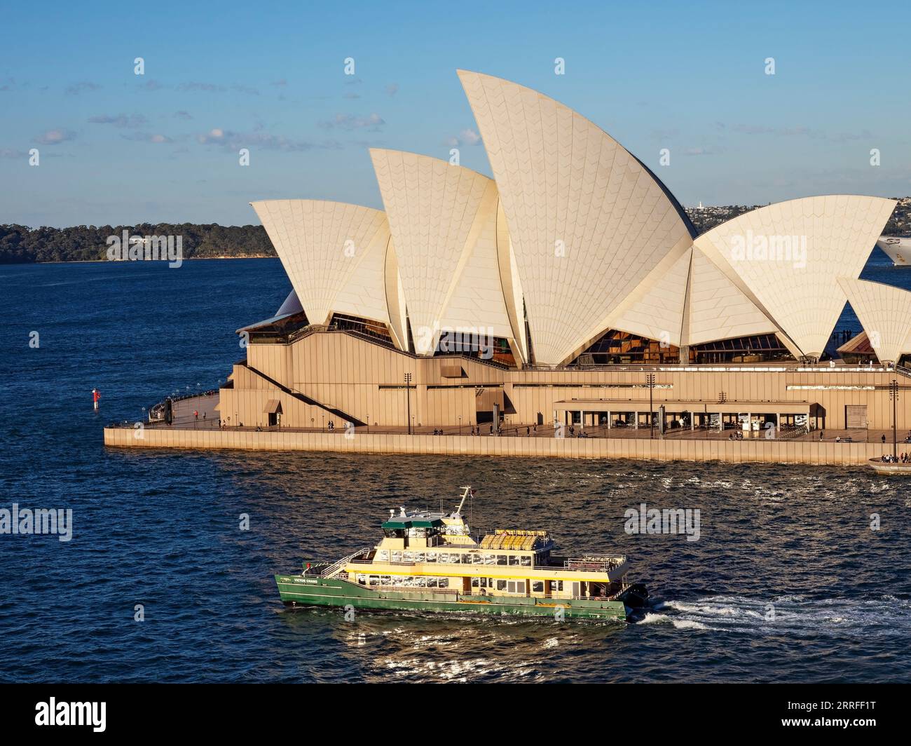 Sydney Australia / A Sydney commuter ferry passes the Sydney Opera ...